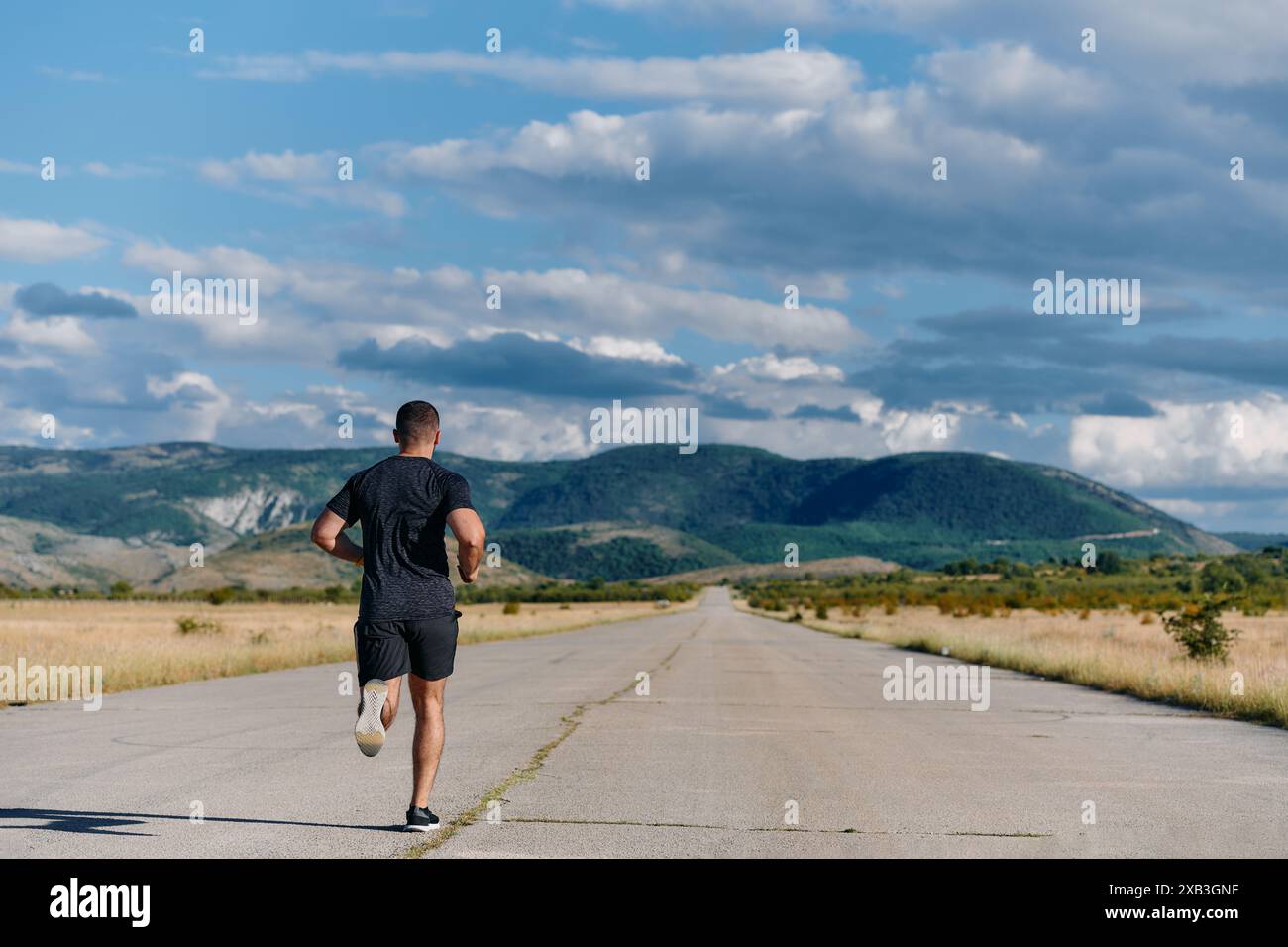 Athletic Man Jogging in the Sun, Preparing His Body for Life's Extreme ...