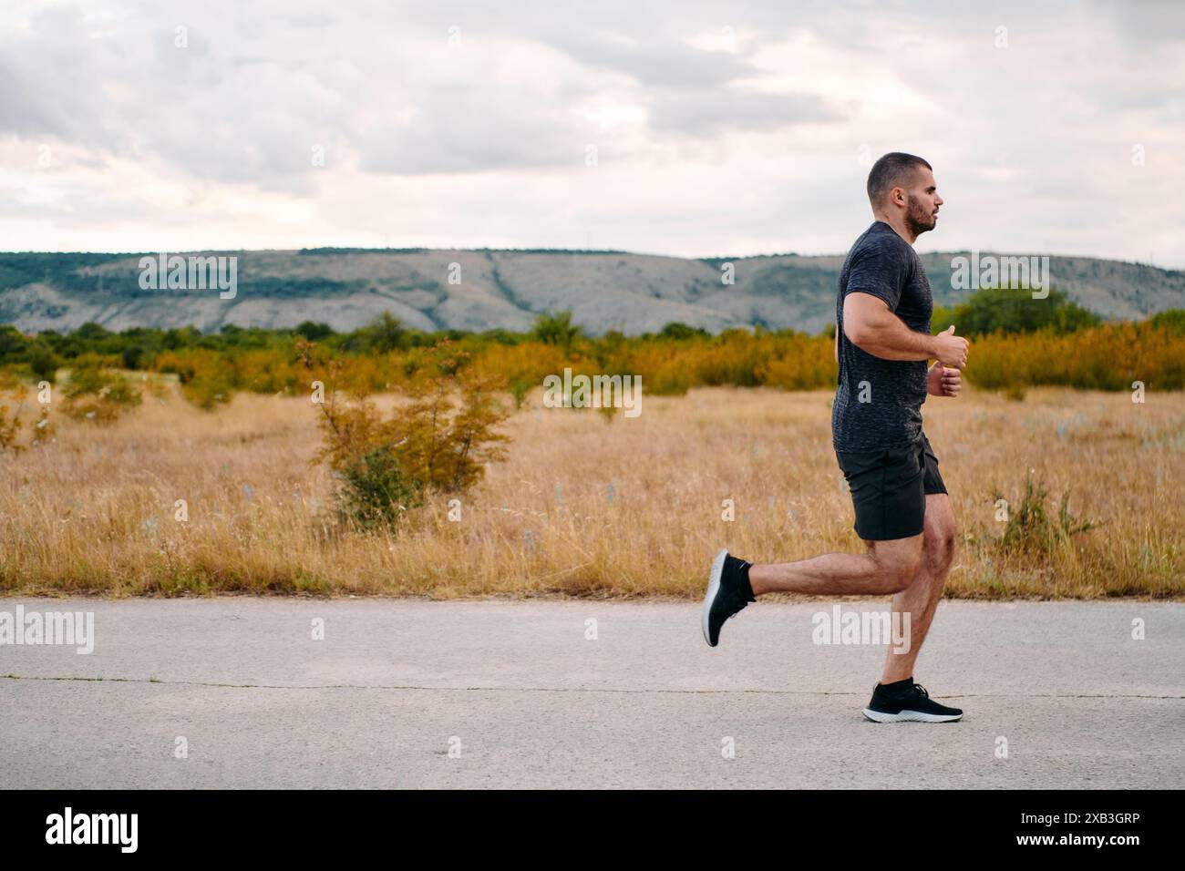 Athletic Man Jogging in the Sun, Preparing His Body for Life's Extreme Challenges Stock Photo ...