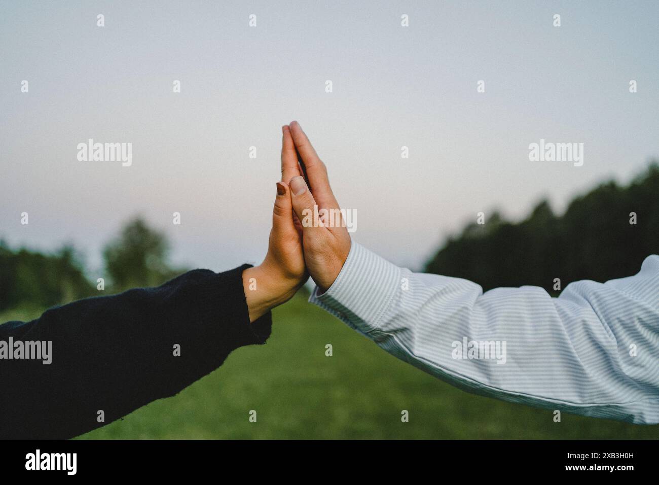 Hands of young couple touching each other against clear sky Stock Photo ...