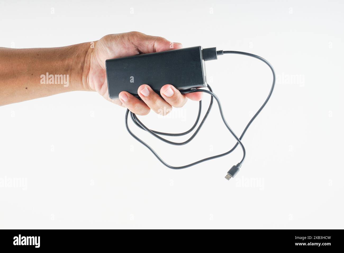 hand holding power bank charger with wire on white backgroumd Stock ...