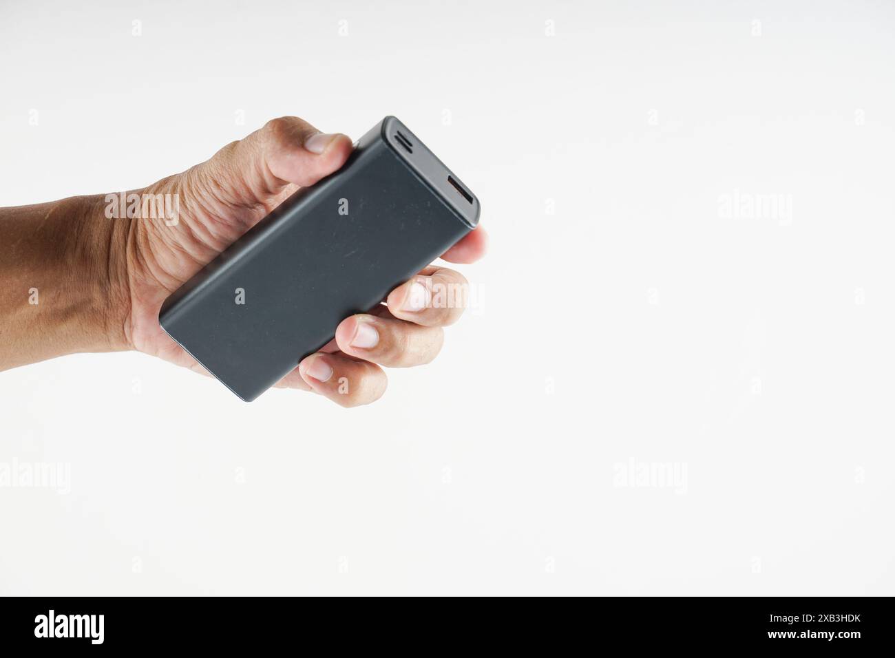 Hand holding power bank charger on white backgroumd Stock Photo - Alamy