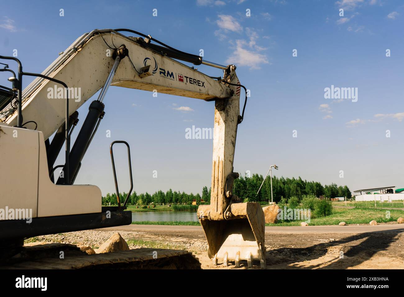 Excavator in a quarry extracting stone, soil ground Stock Photo - Alamy