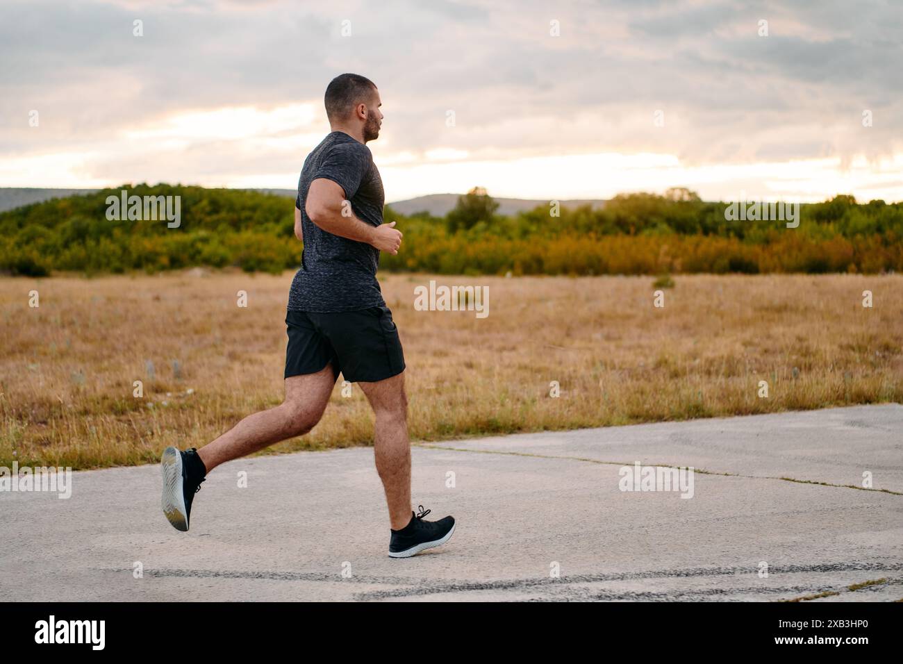 Athletic Man Jogging in the Sun, Preparing His Body for Life's Extreme Challenges Stock Photo ...