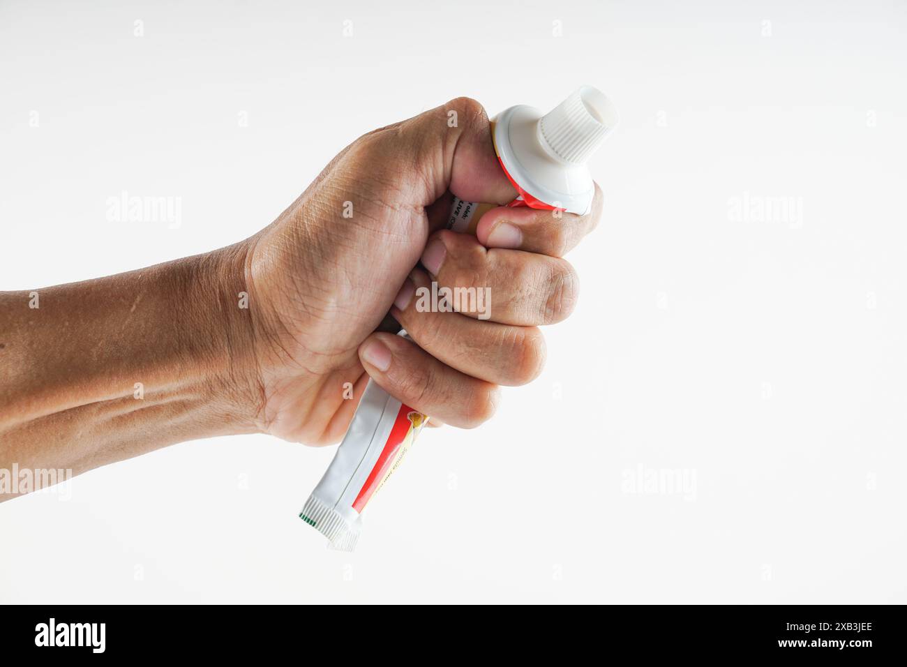 squeeze the toothpaste bottle on white background Stock Photo - Alamy
