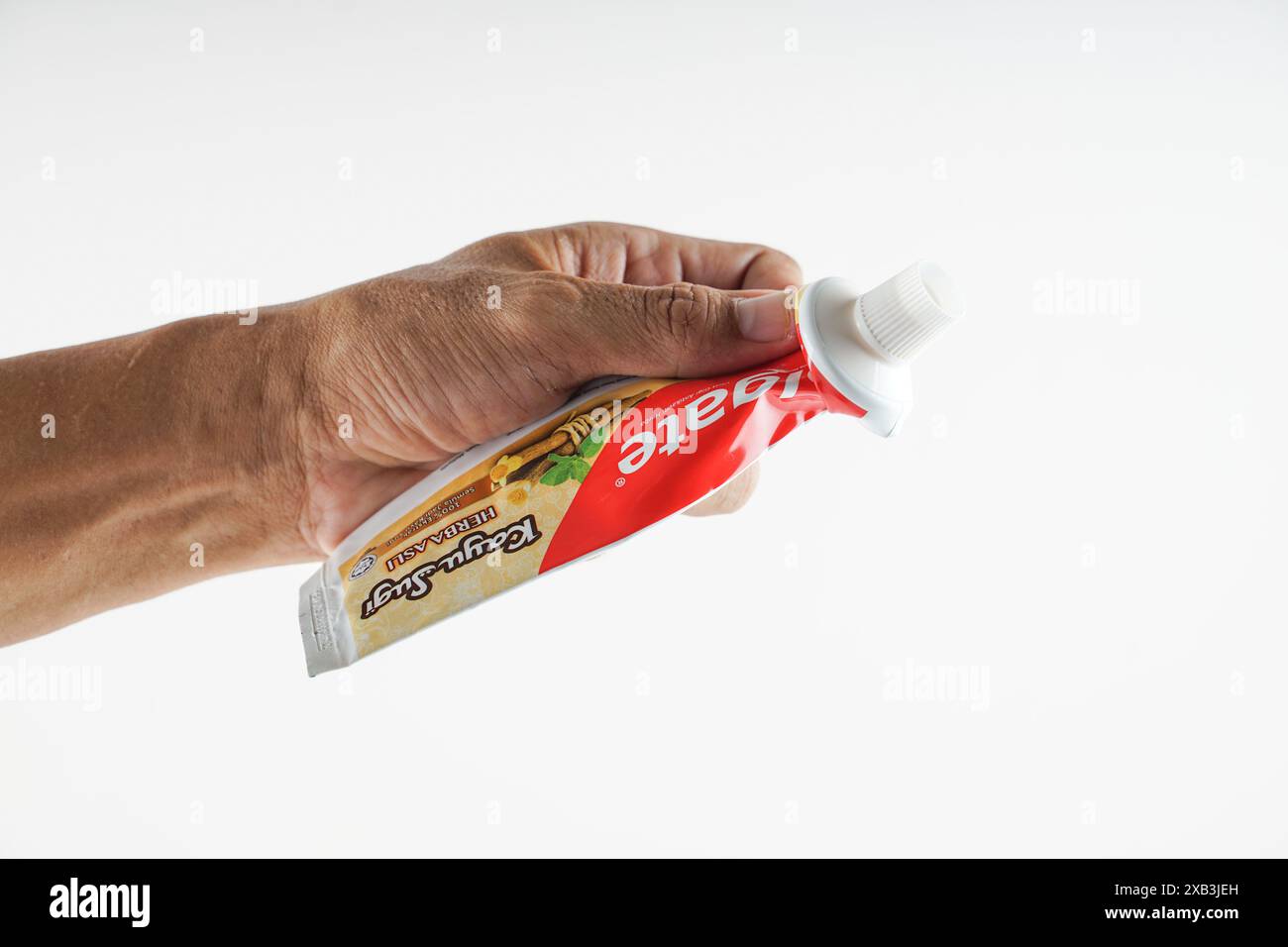 squeeze the toothpaste bottle on white background Stock Photo - Alamy