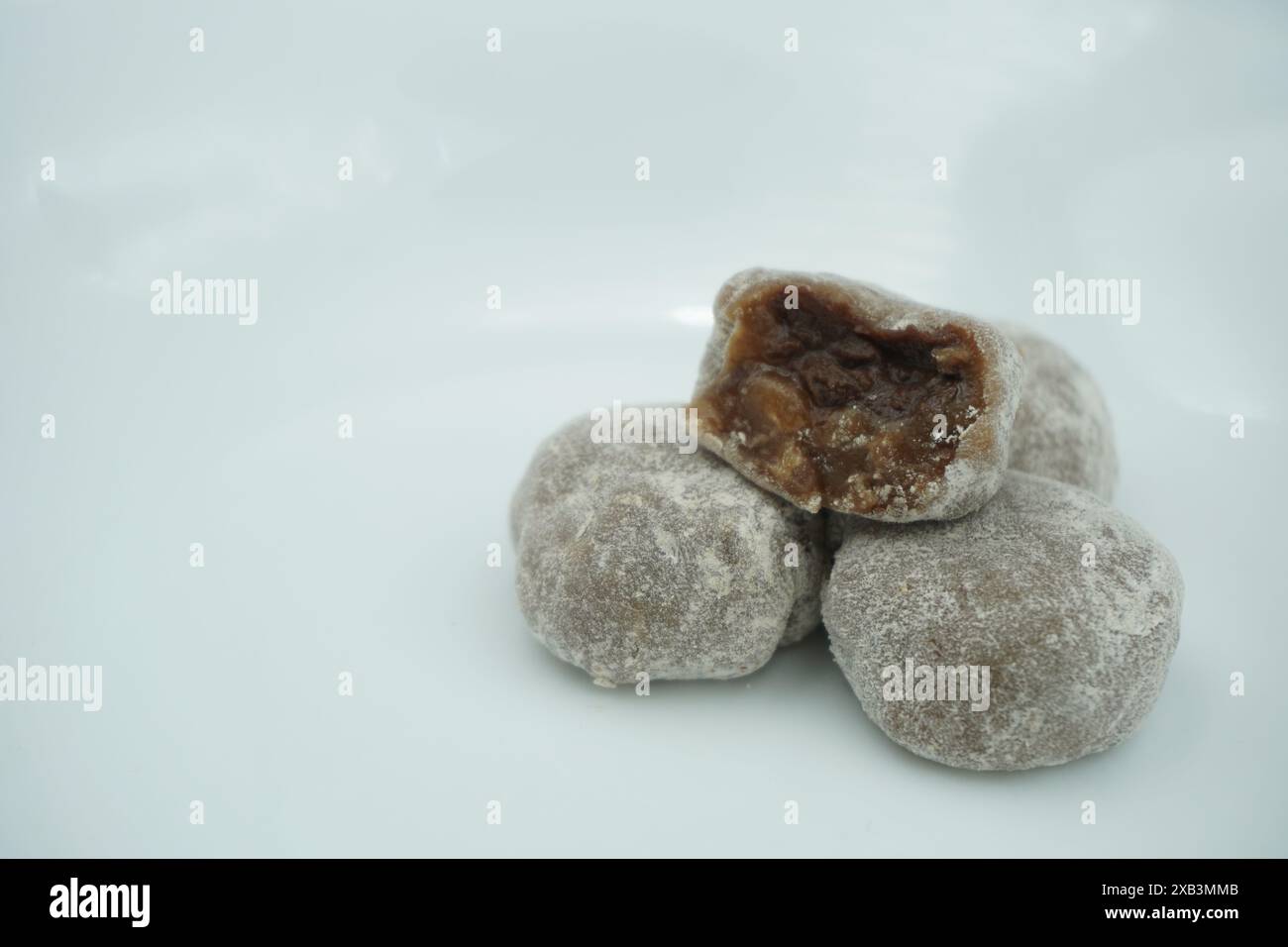 Mochi with white powder that has been opened with chocolate filling and ...