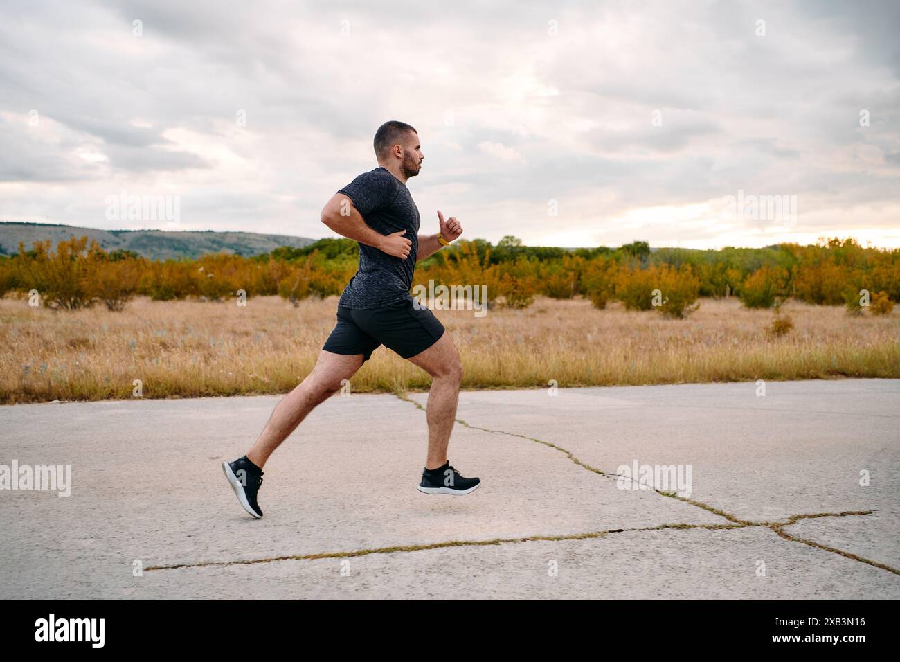 Athletic Man Jogging in the Sun, Preparing His Body for Life's Extreme Challenges Stock Photo ...
