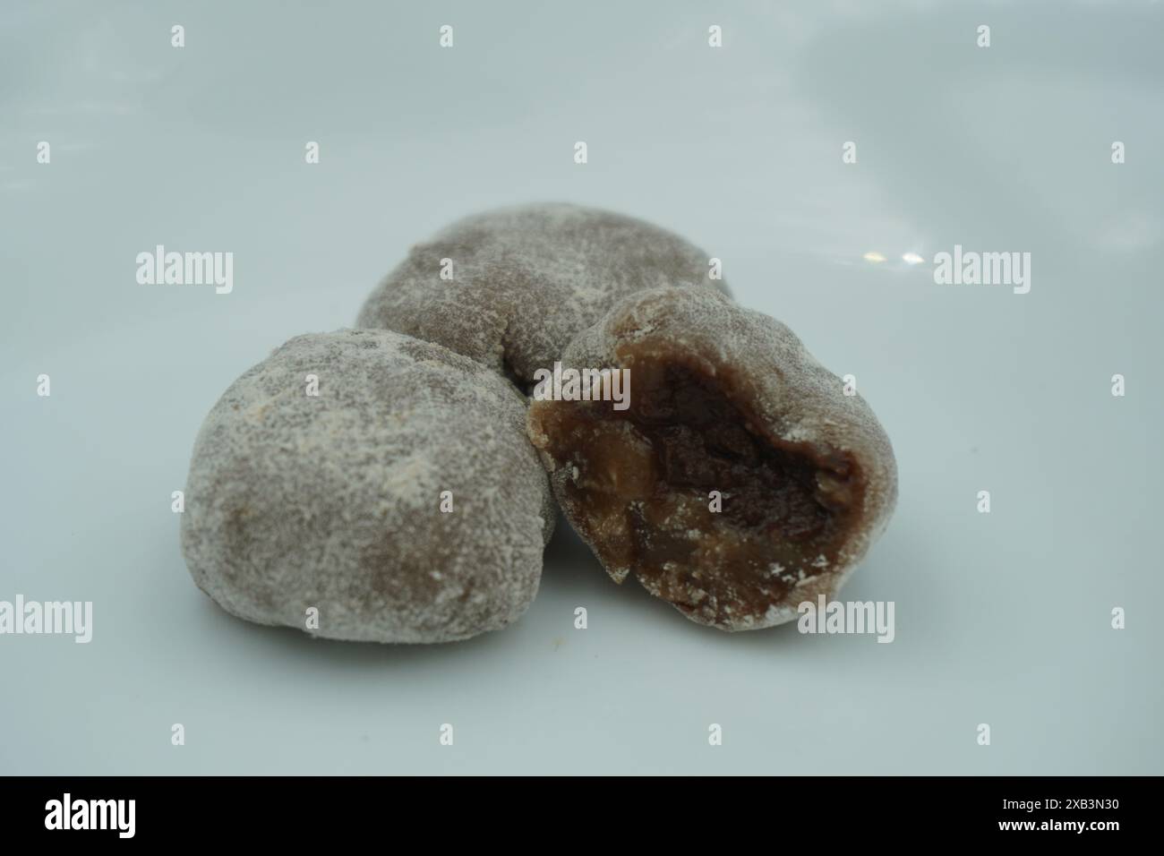 Mochi with white powder that has been opened with chocolate filling and ...