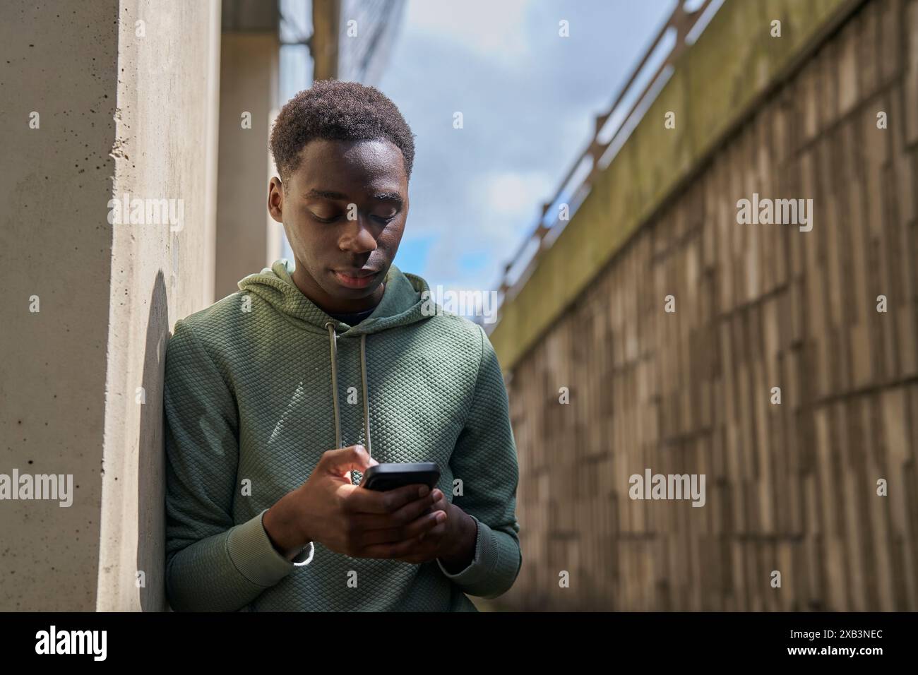 Teenage Boy Checking Social Media Or Text Messaging On Mobiile Phone ...