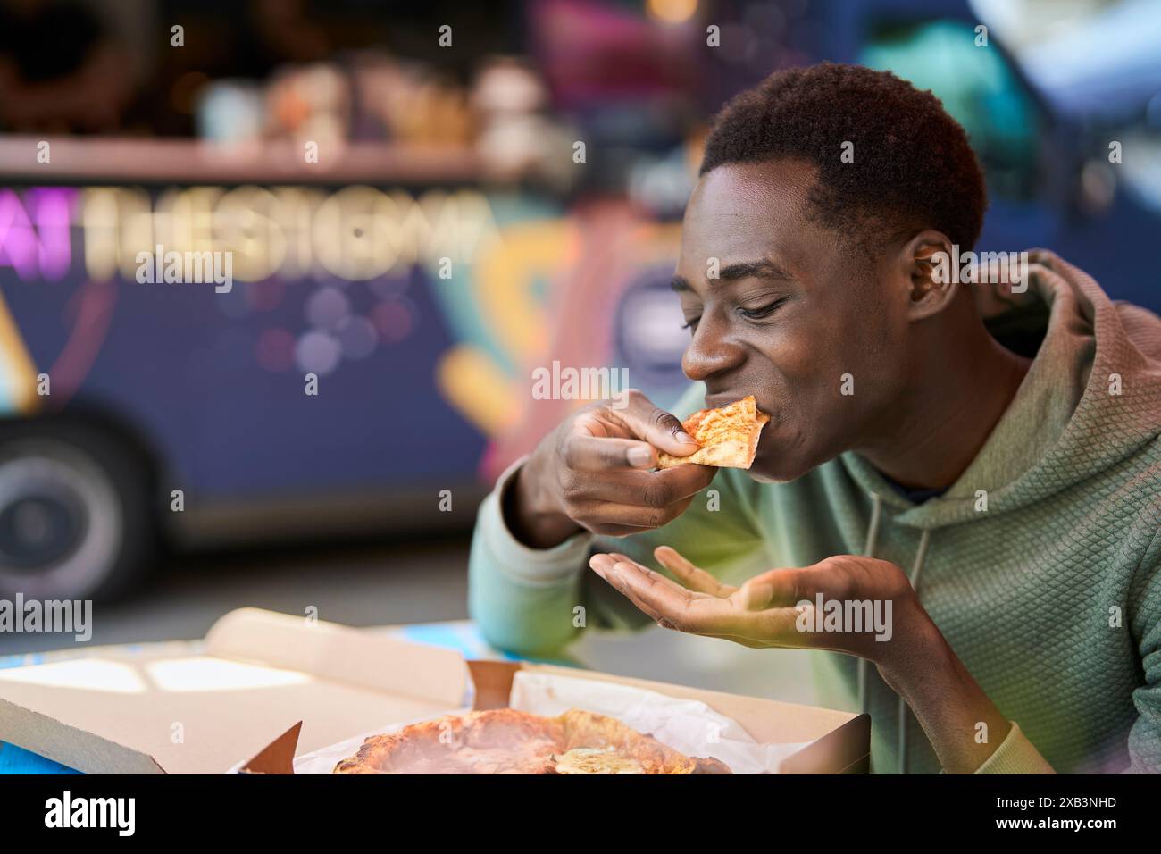 Teenage Boy Eating Pizza At Outdoor Street Food Market Stock Photo - Alamy