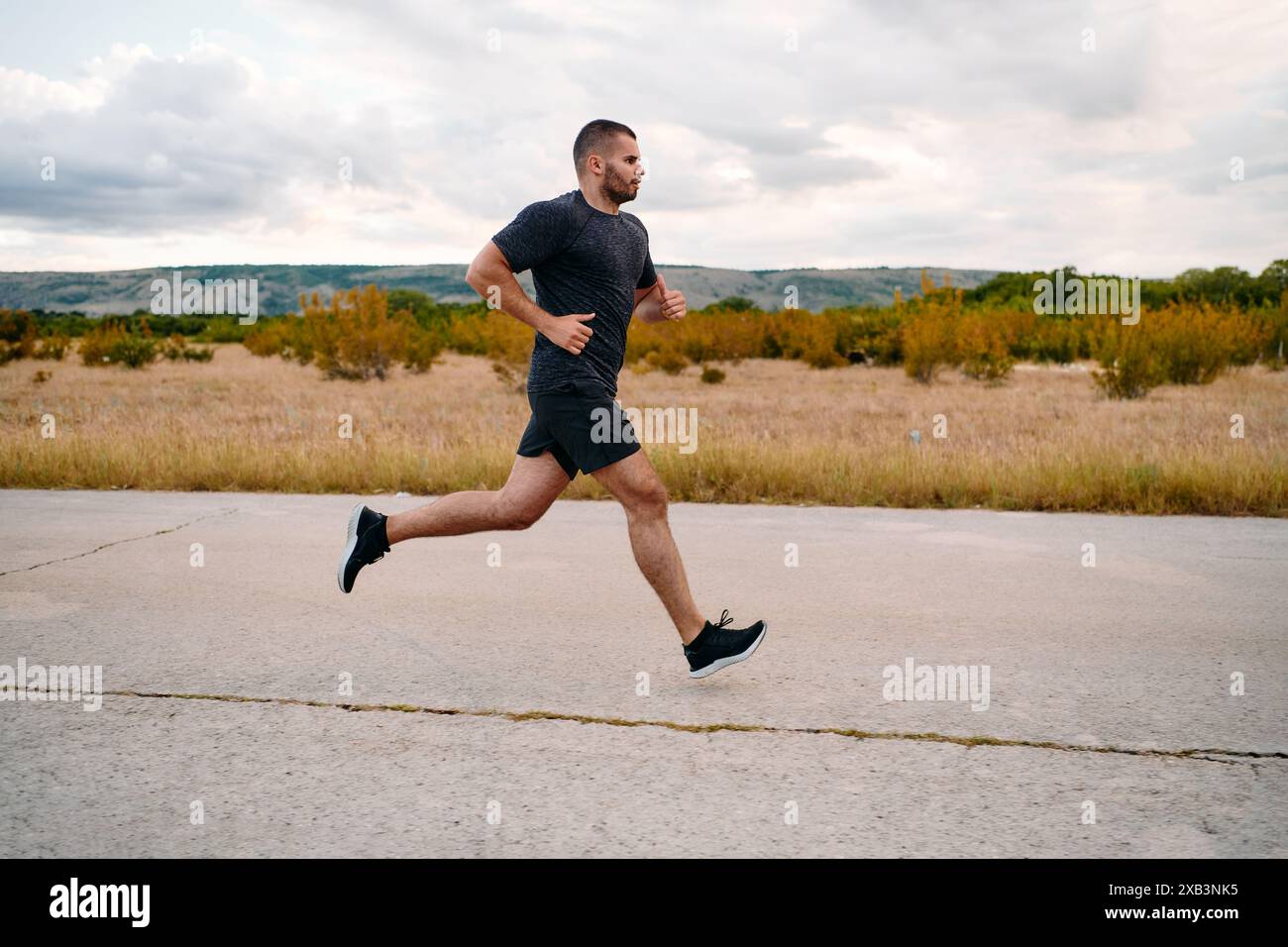 Athletic Man Jogging in the Sun, Preparing His Body for Life's Extreme Challenges Stock Photo ...