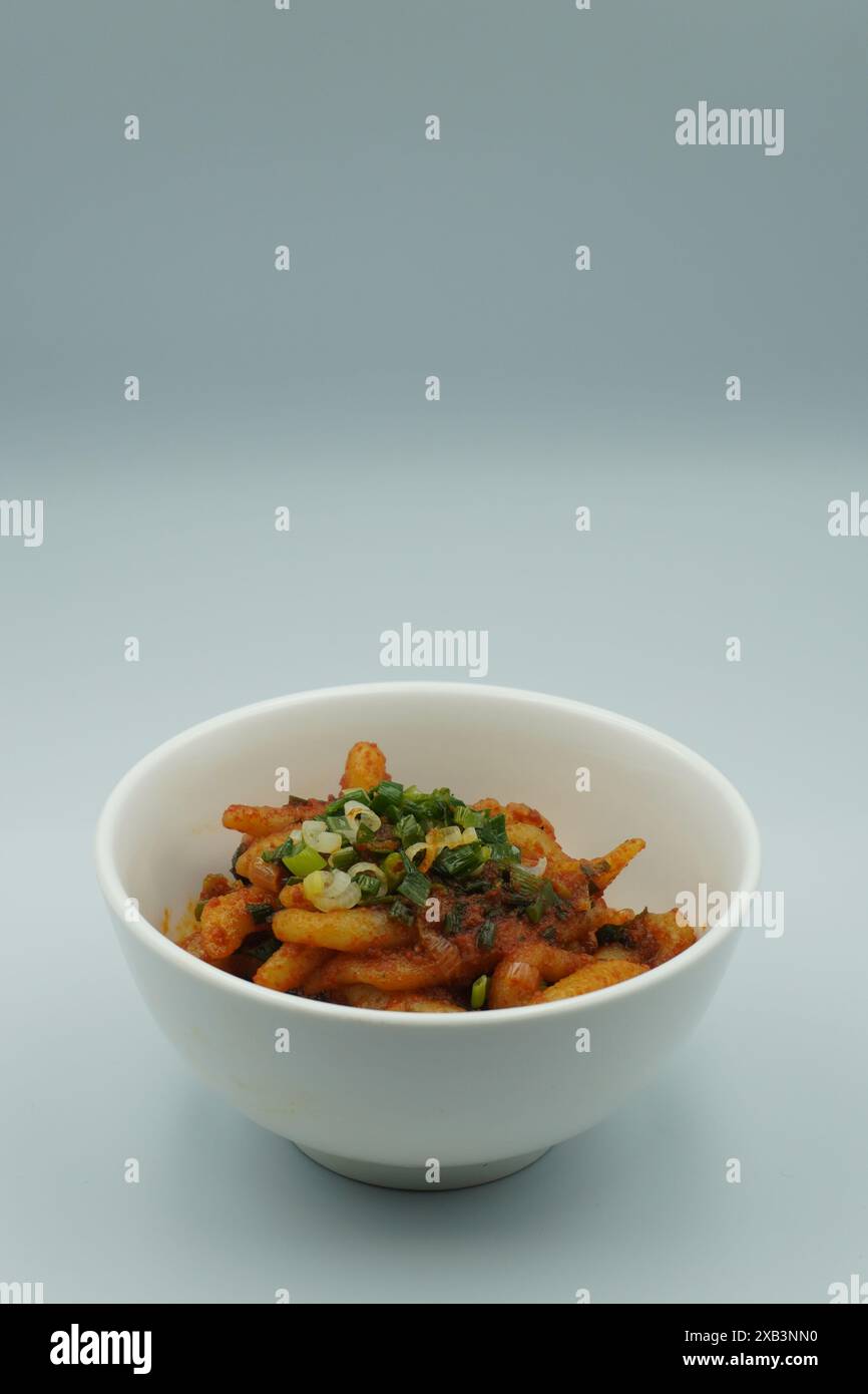 A bowl of spicy lou shu fan with spring onions on top and white ...