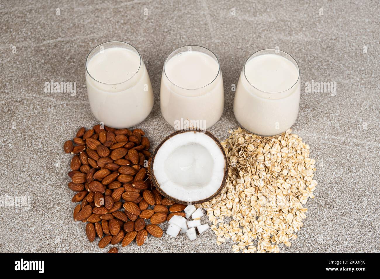 Types of plant-based milk in glasses. Oat, coconut and almond milk ...