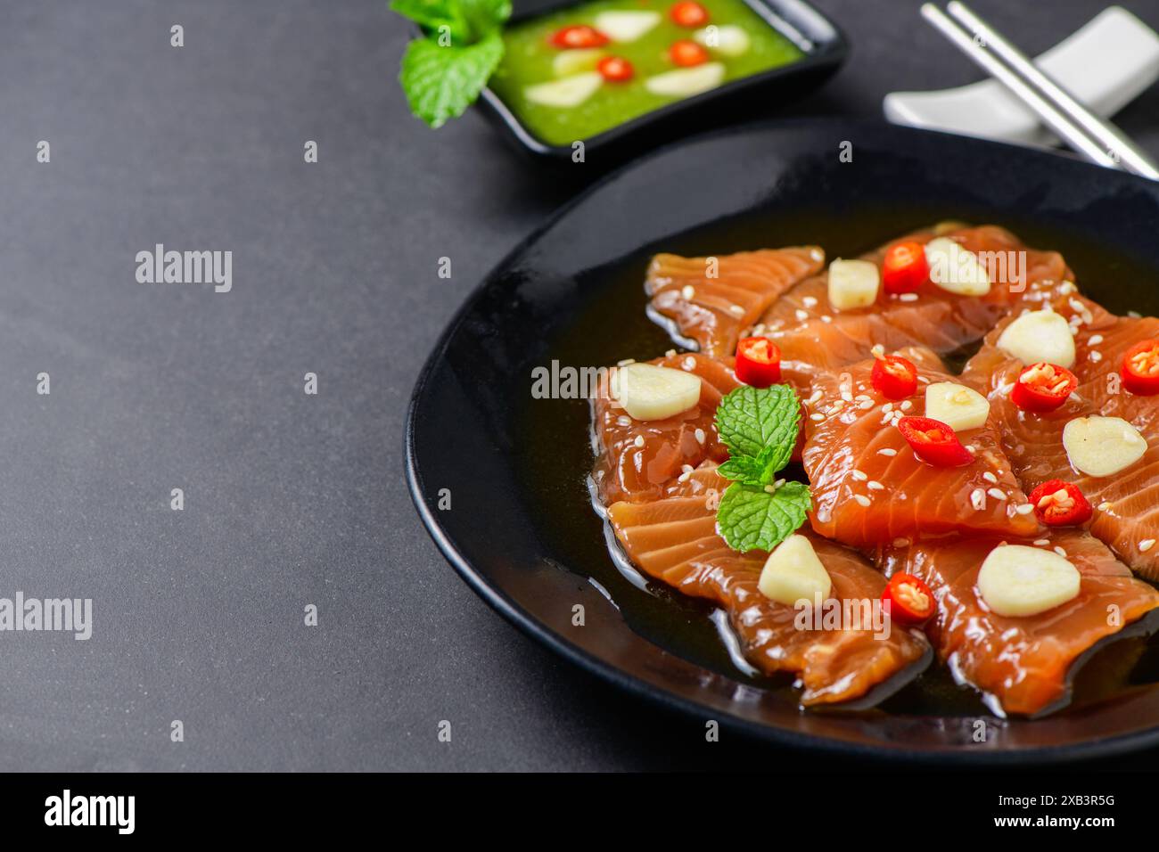 Pickled Salmon with Soy Sauce with chilli and garlic on stone ...