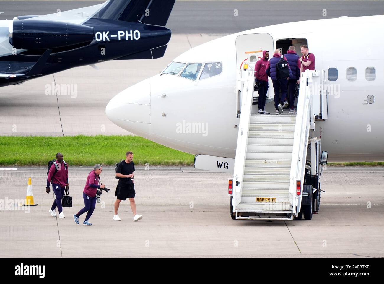 England's Harry Kane prepares to board a plane at Birmingham Airport ...
