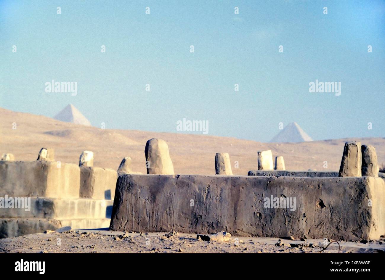 Old grave yard with at the background the pyramids of Gizeh, Cairo ...