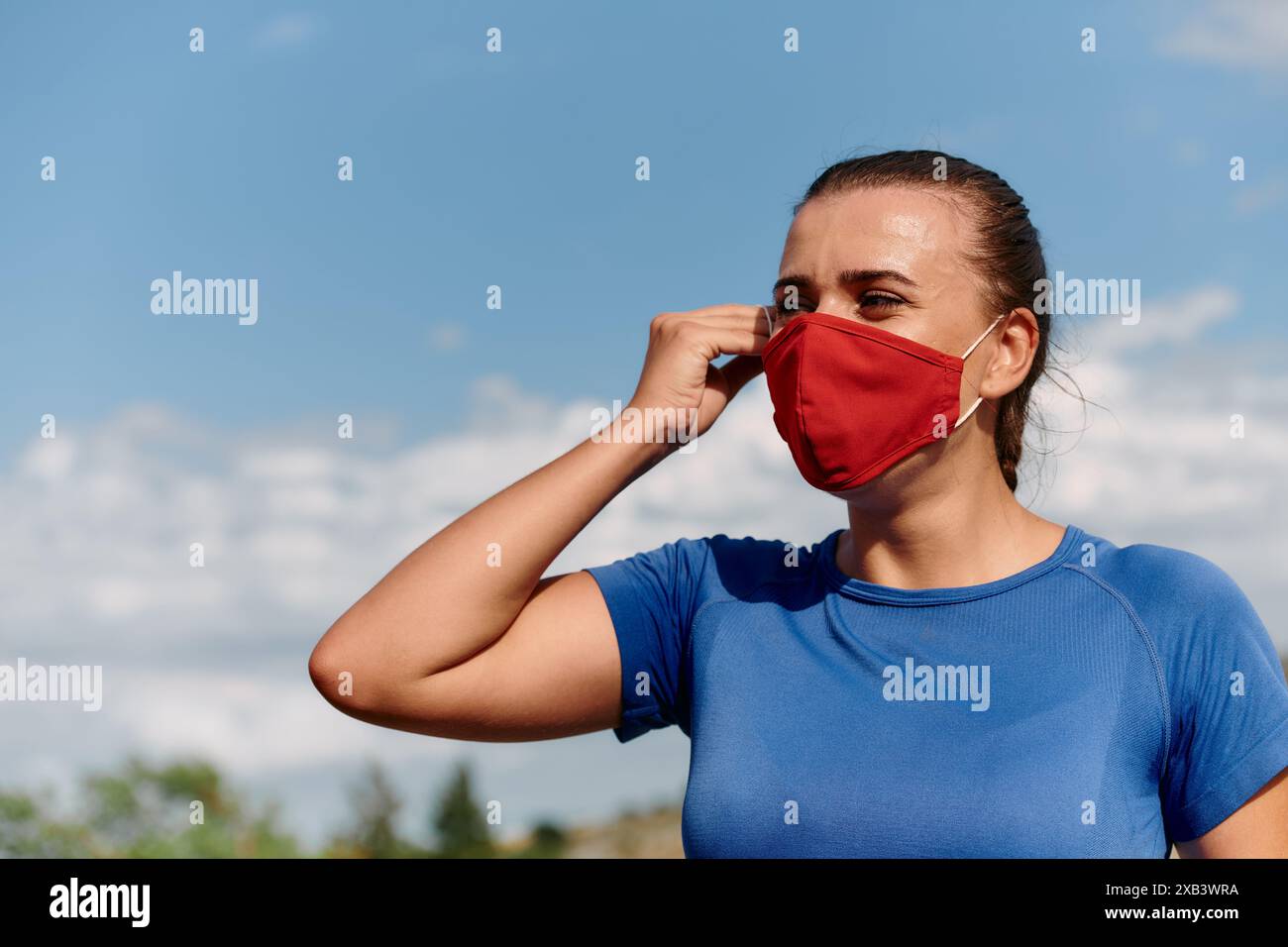 Athlete woman is getting ready to run with a mask on her face Stock ...