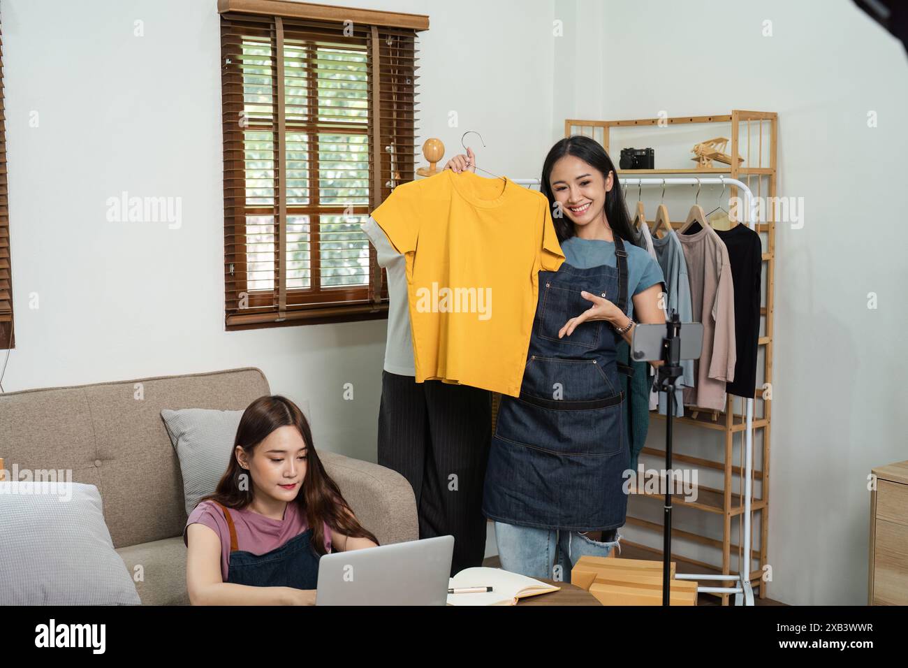 Young Online E-Business Owners Working from Home, Showcasing Clothing ...