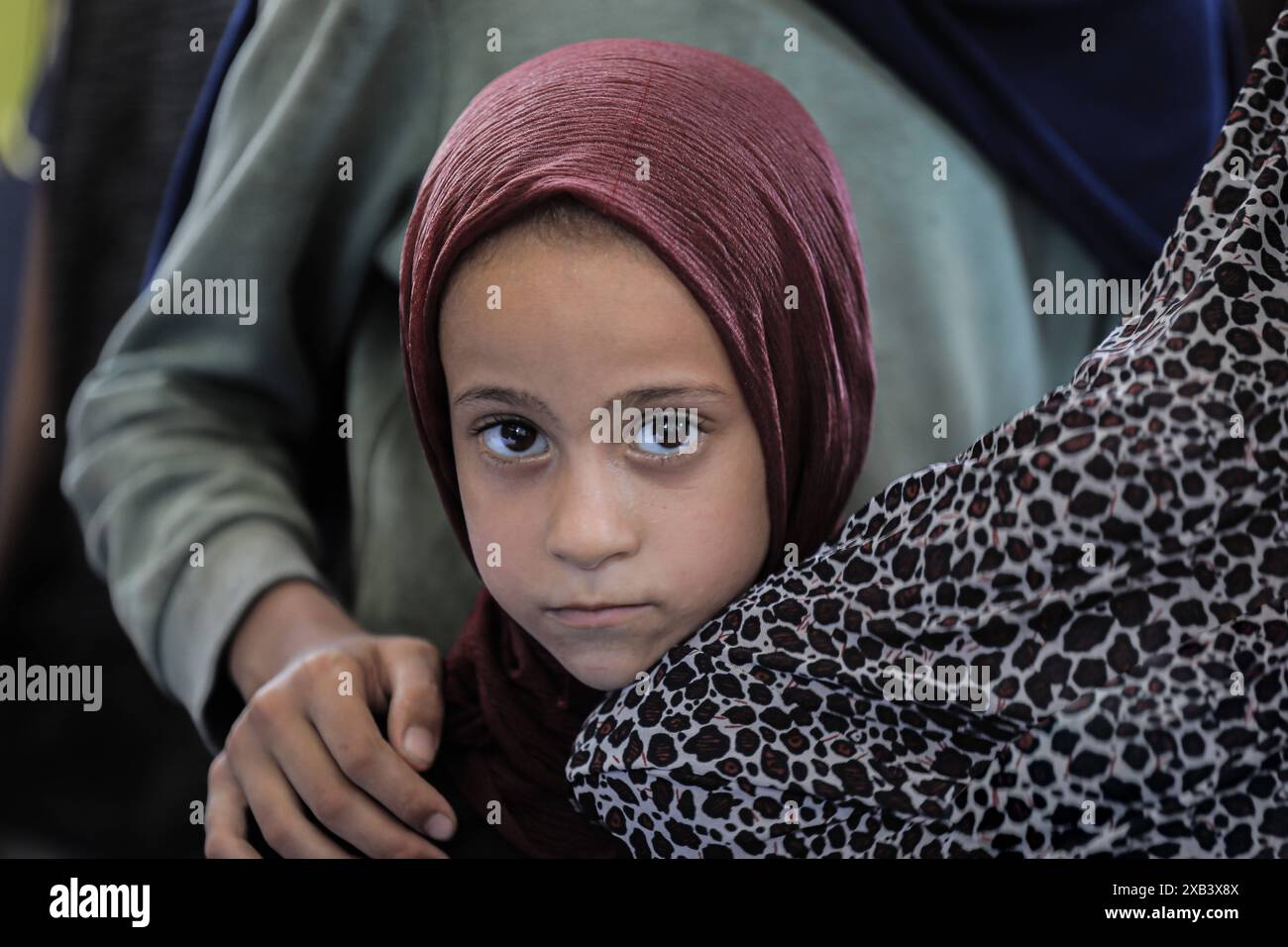 Displaced Palestinian children gather around a makeshift cube ...