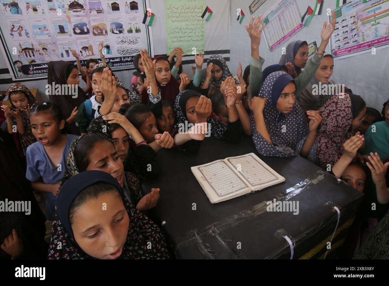 Displaced Palestinian children gather around a makeshift cube ...