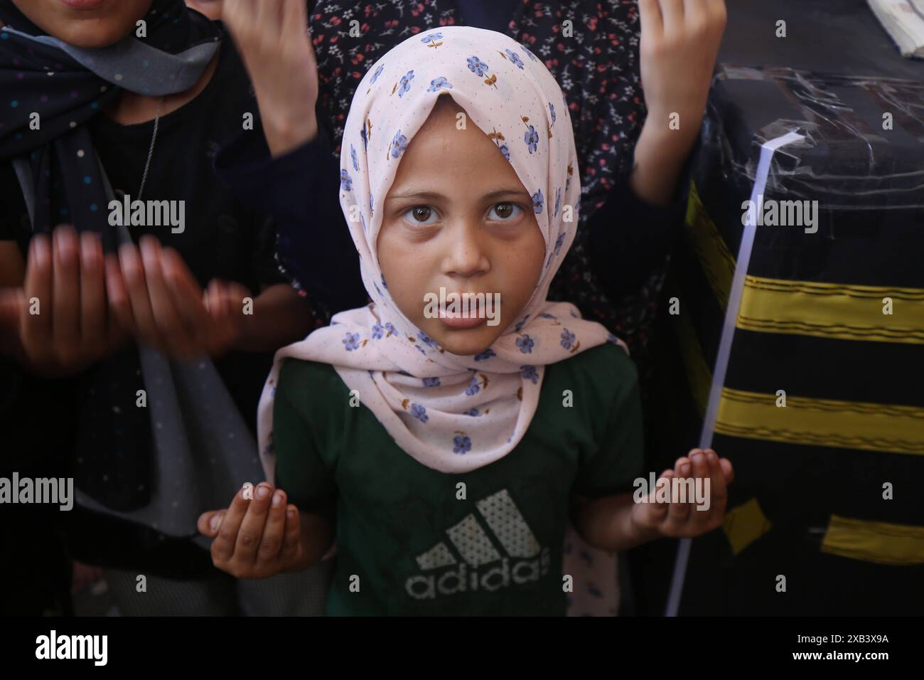 Displaced Palestinian children gather around a makeshift cube ...