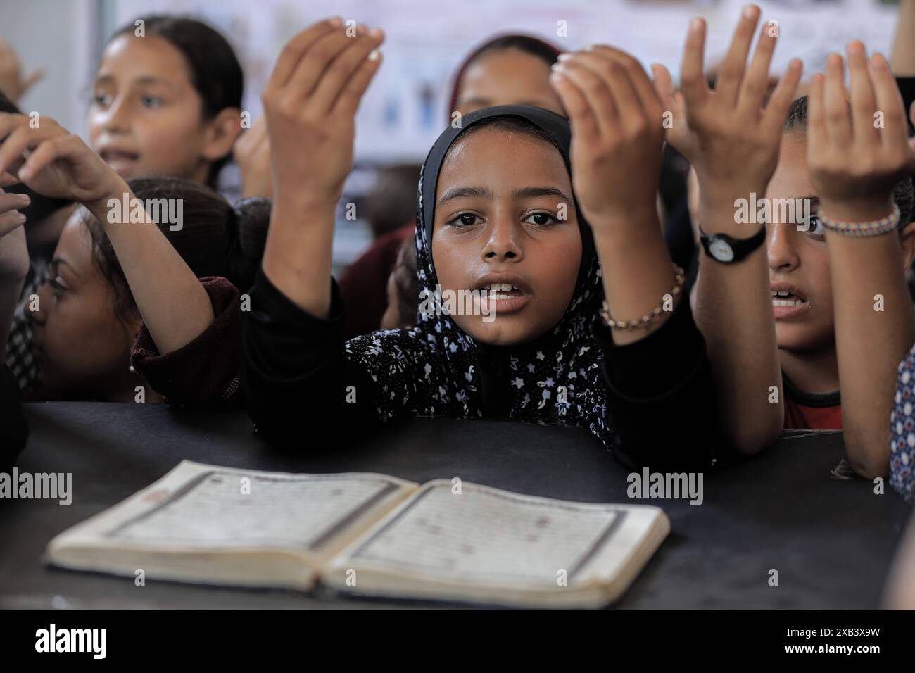 Displaced Palestinian children gather around a makeshift cube ...
