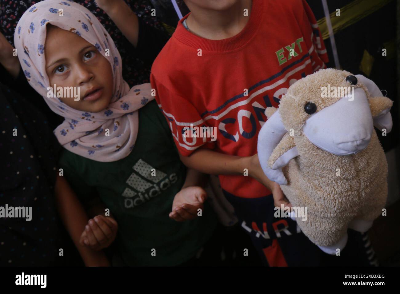 Displaced Palestinian children gather around a makeshift cube ...