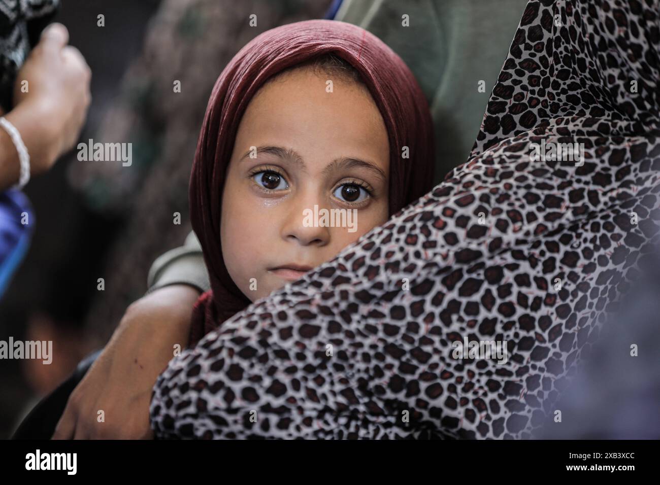 Displaced Palestinian children gather around a makeshift cube ...