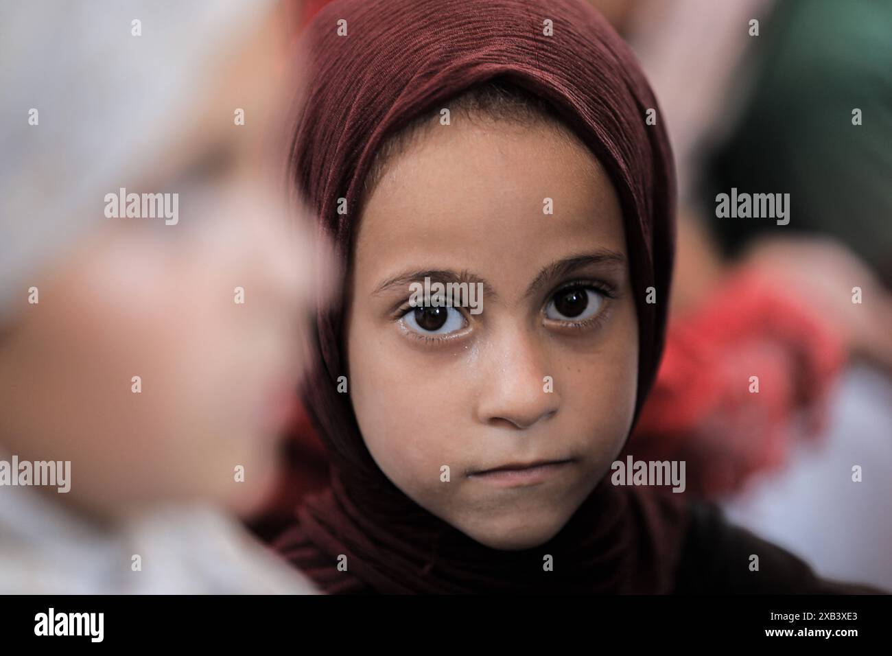 Displaced Palestinian children gather around a makeshift cube ...
