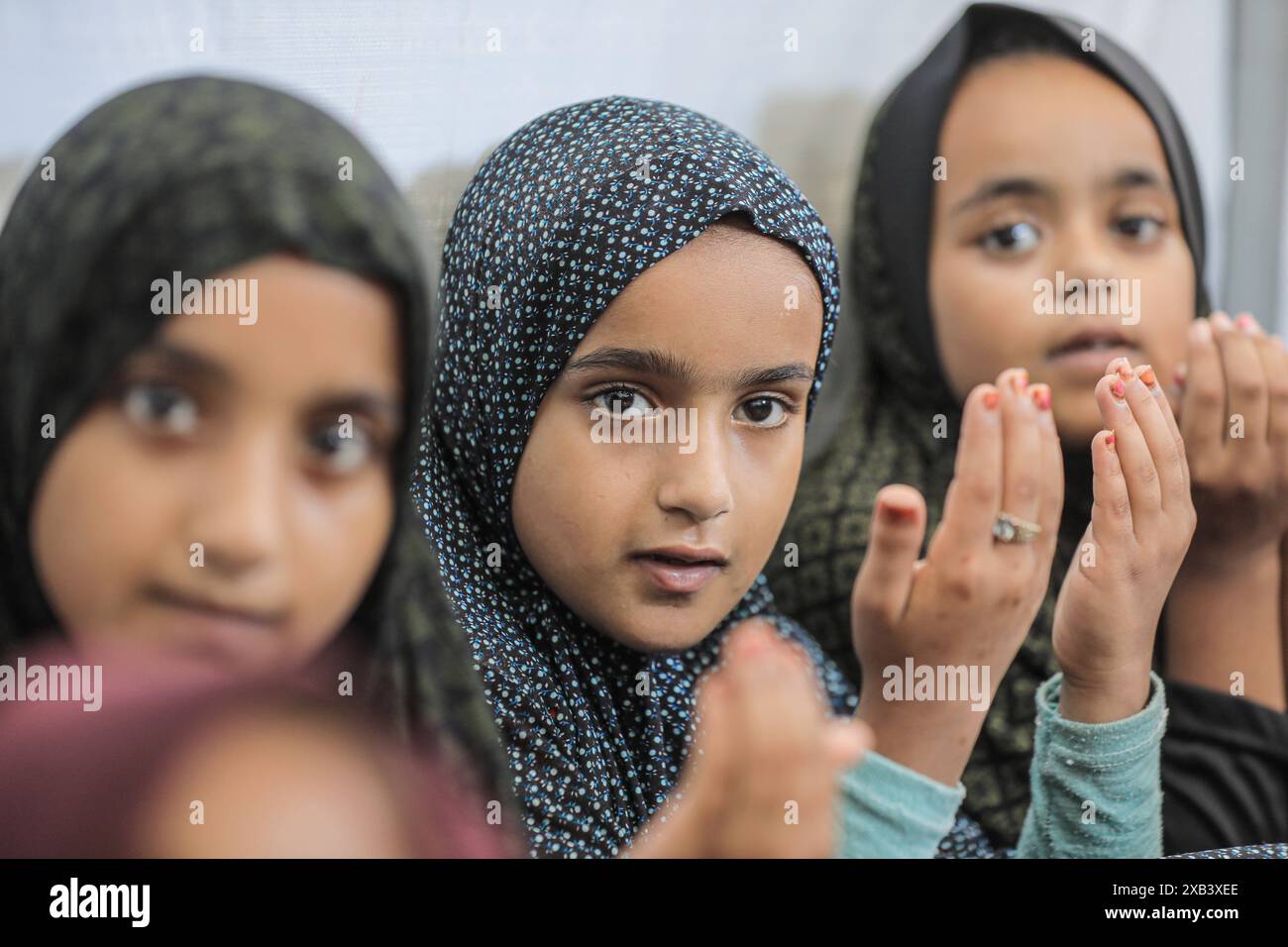 Displaced Palestinian children gather around a makeshift cube ...