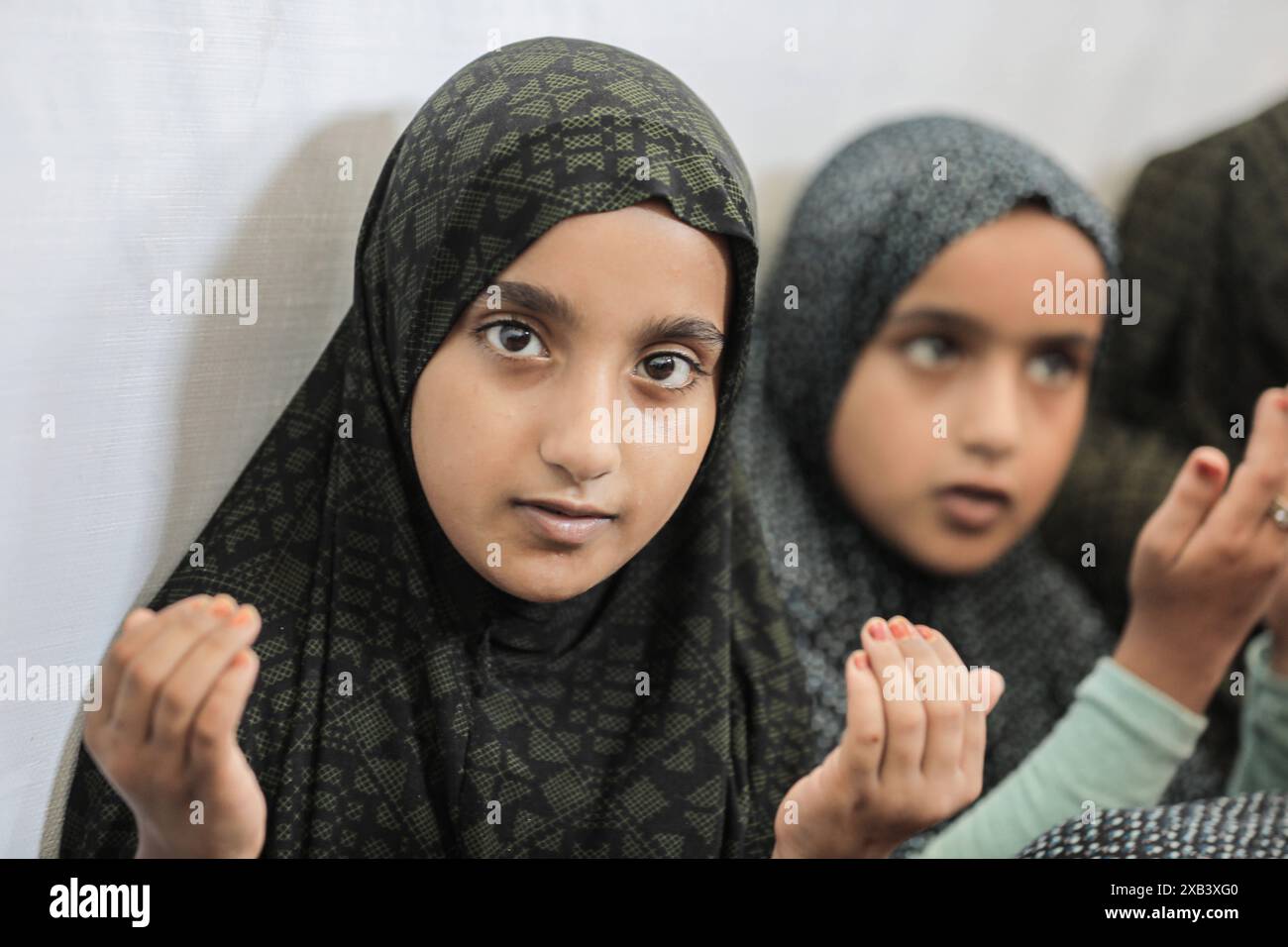 Displaced Palestinian children gather around a makeshift cube ...