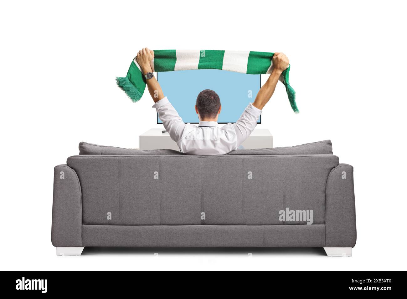 Back view of a man cheering with a scarf in front of a tv screen ...