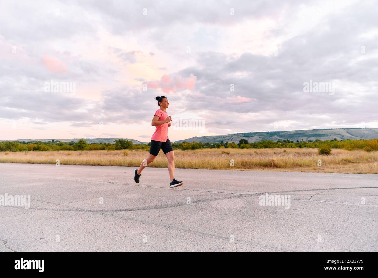 Determined Athlete Running in the Sun amidst Beautiful Nature Stock ...