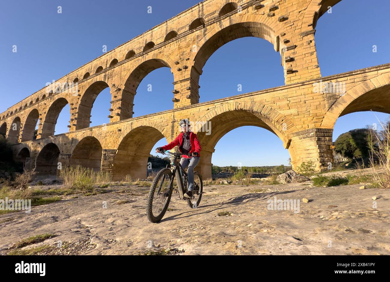 senior woman mountainbiking with her electric bike below the famous ...