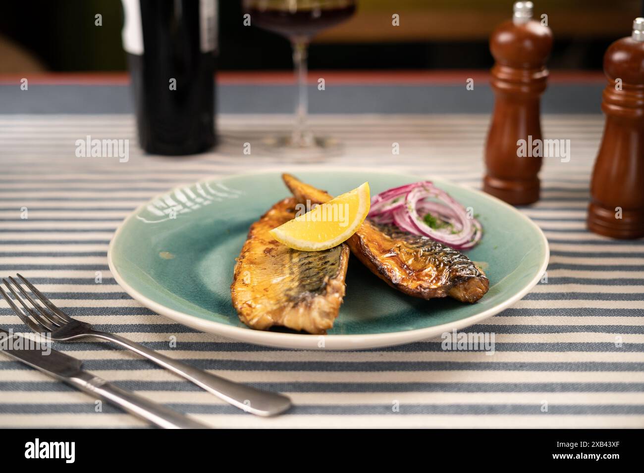 Restaurant menu. Mackerel fillet served on a white plate with a slice ...