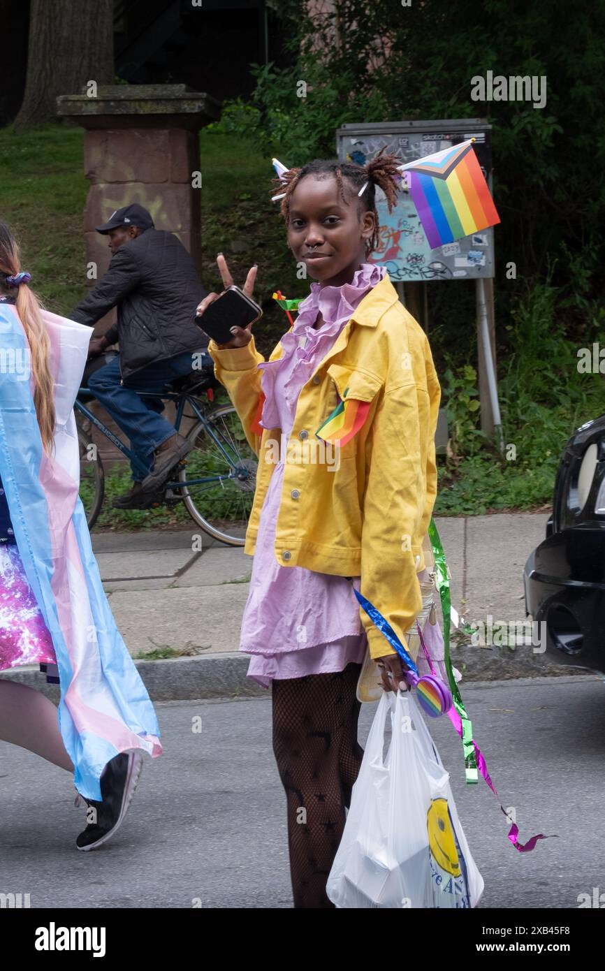 A Marcher In The 2024 Poughkeepsie Pride Parade Flashing A Peace Sign And Wearing A Pride Flag