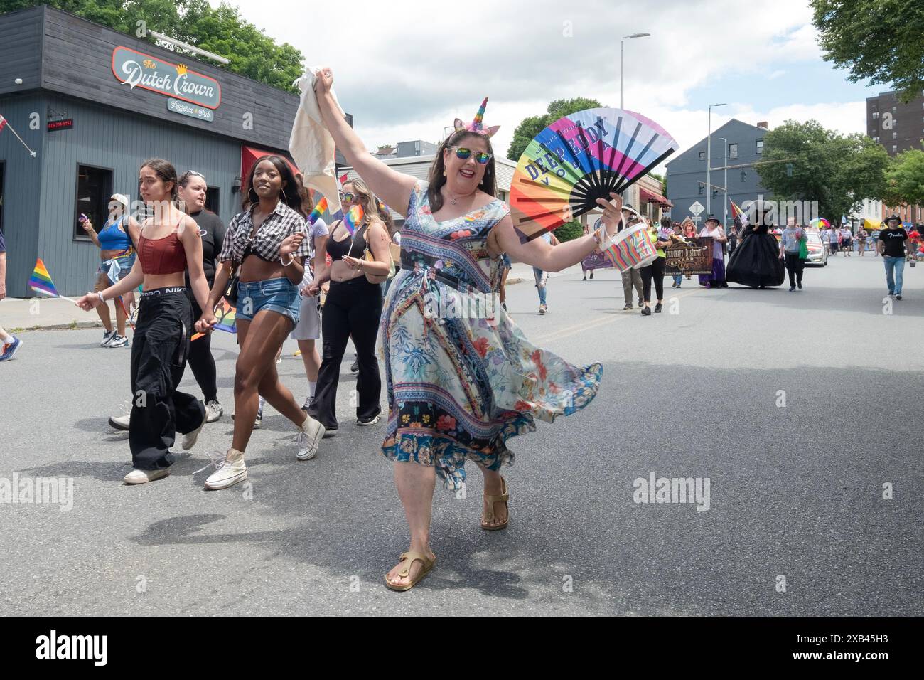 An animated marcher in the 2024 Poughkeepsie Pride Parade holding and ...