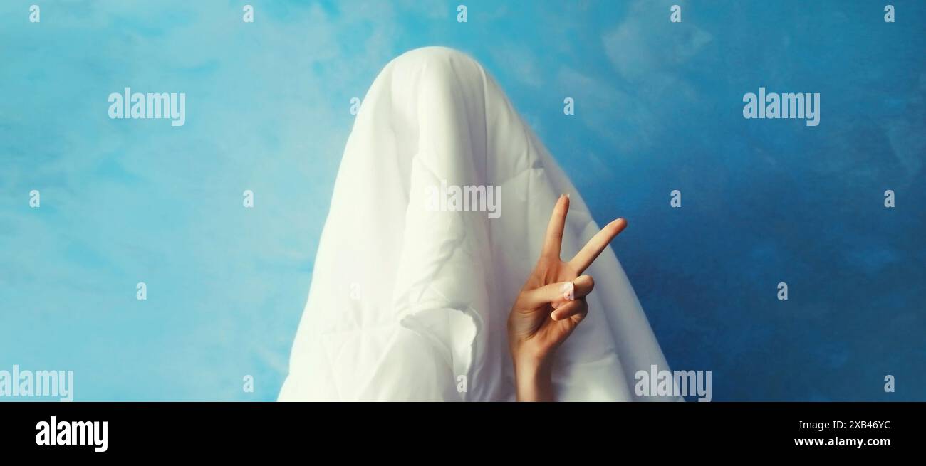 Cheerful lazy woman waking up after sleeping covered head with white ...