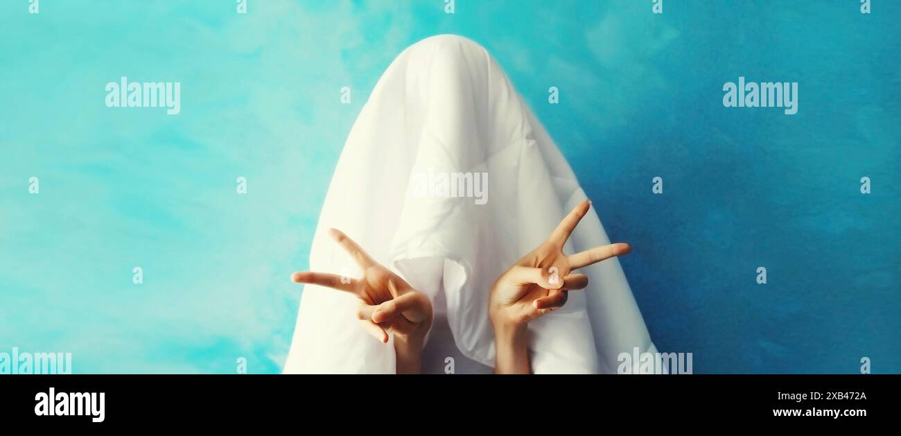 Cheerful lazy woman waking up after sleeping covered head with white ...