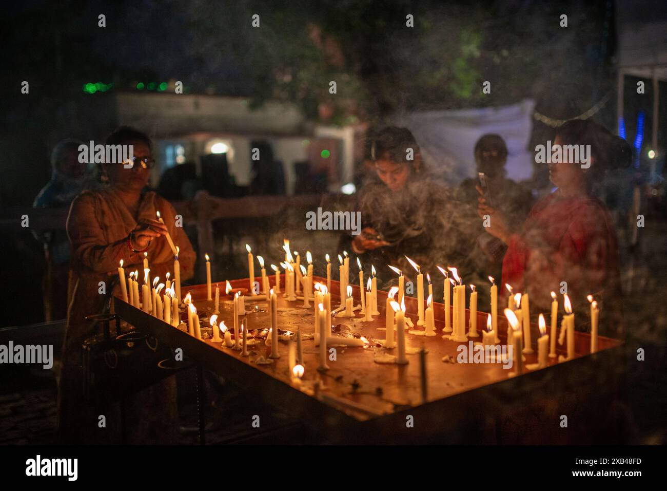 Devotees lit candles at the Sri Sri Baradeswari Kalimata Temple at ...