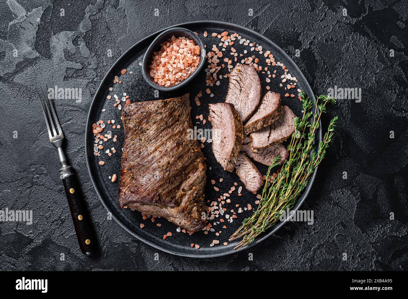 Barbecue dry aged wagyu Tri Tip beef steak on a plate with pink salt ...