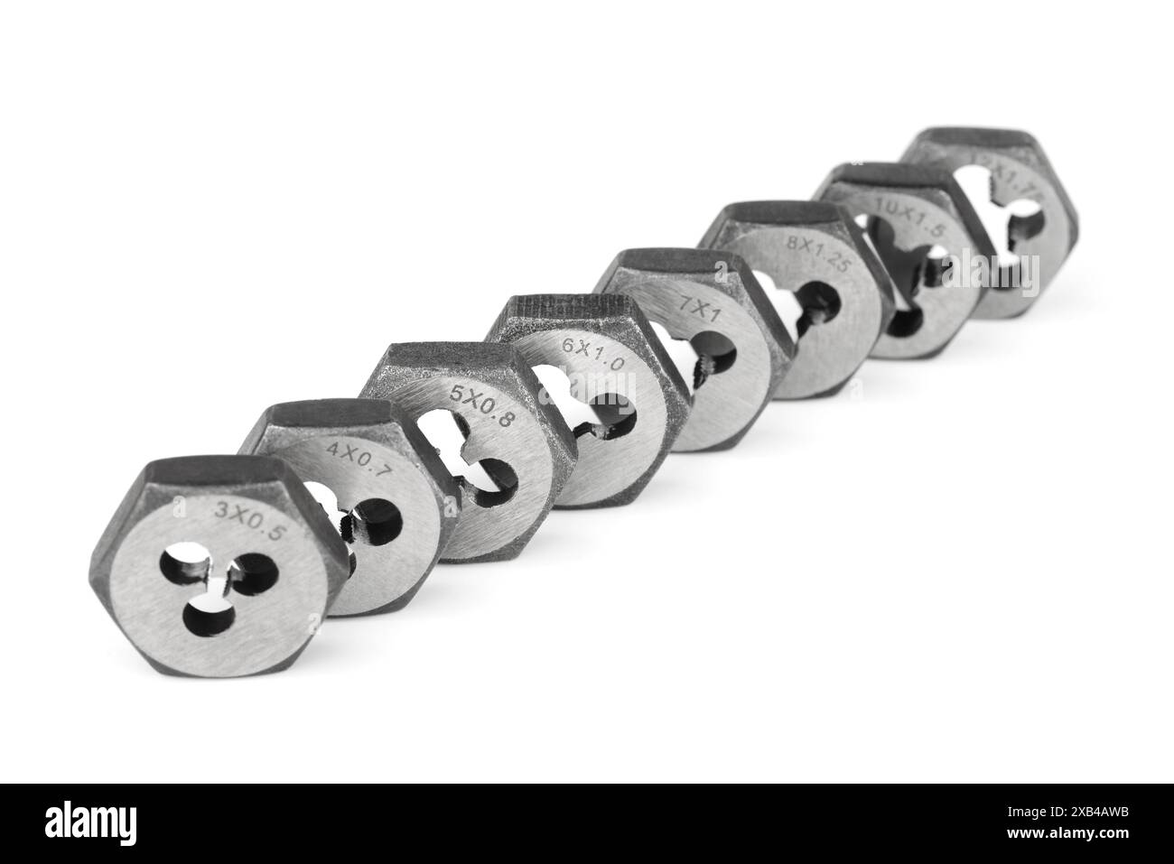 Row of threading dies of different sizes isolated on white Stock Photo ...