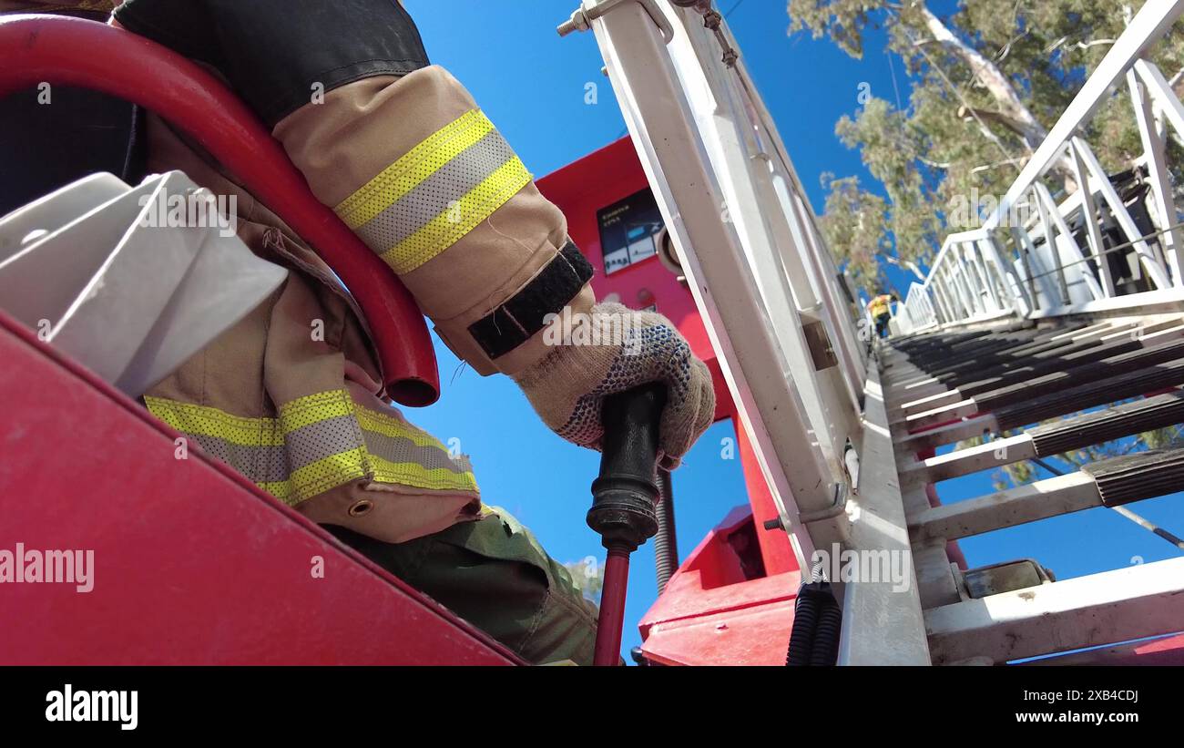 Firefighter doing tree rescue on top of ladder truck outdoors Stock ...