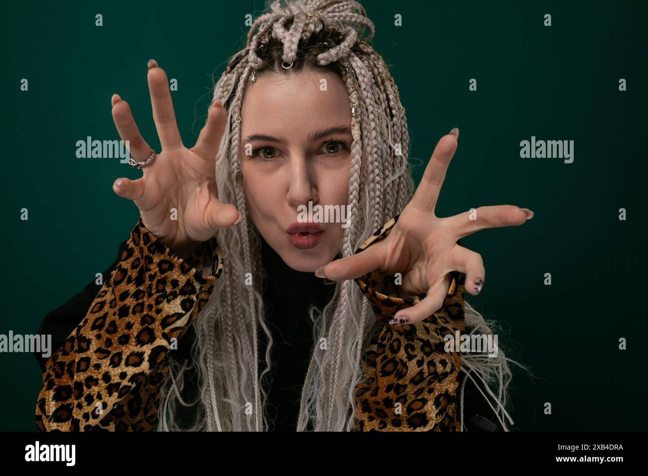 Woman Wearing Leopard Print Jacket Making Peace Sign Stock Photo - Alamy