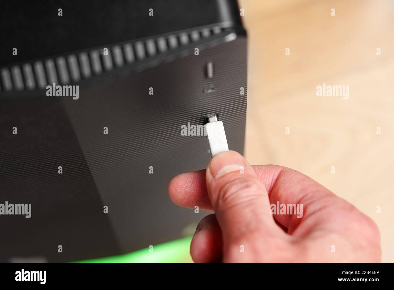 USB cable plug connecting by the user hand to an computer close up ...