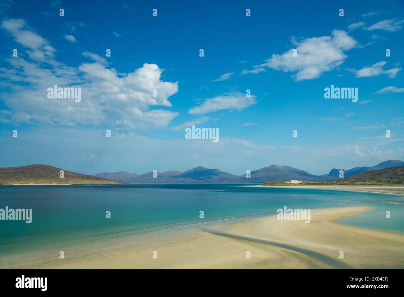 An aerial view of white sand and clear sea at low tide on Seilebost ...