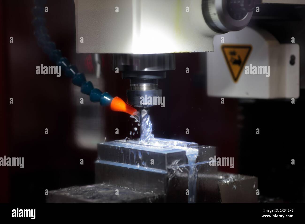 Closeup of metal milling process using CNC machine and cutting fluid ...