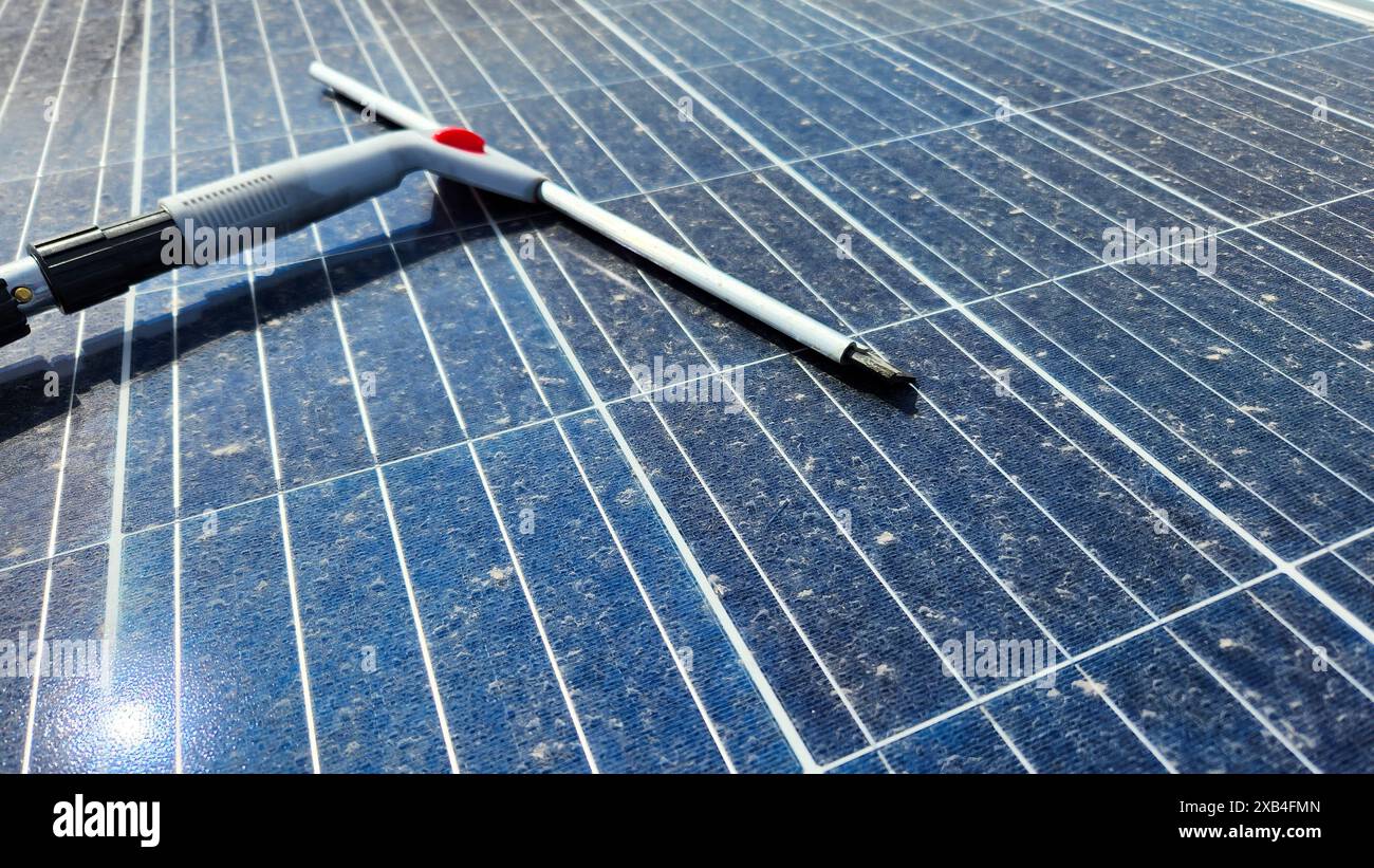 Cleaning dirty solar panels. Maintenance Stock Photo - Alamy