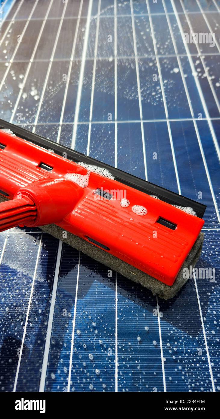 Cleaning dirty solar panels. Maintenance Stock Photo - Alamy