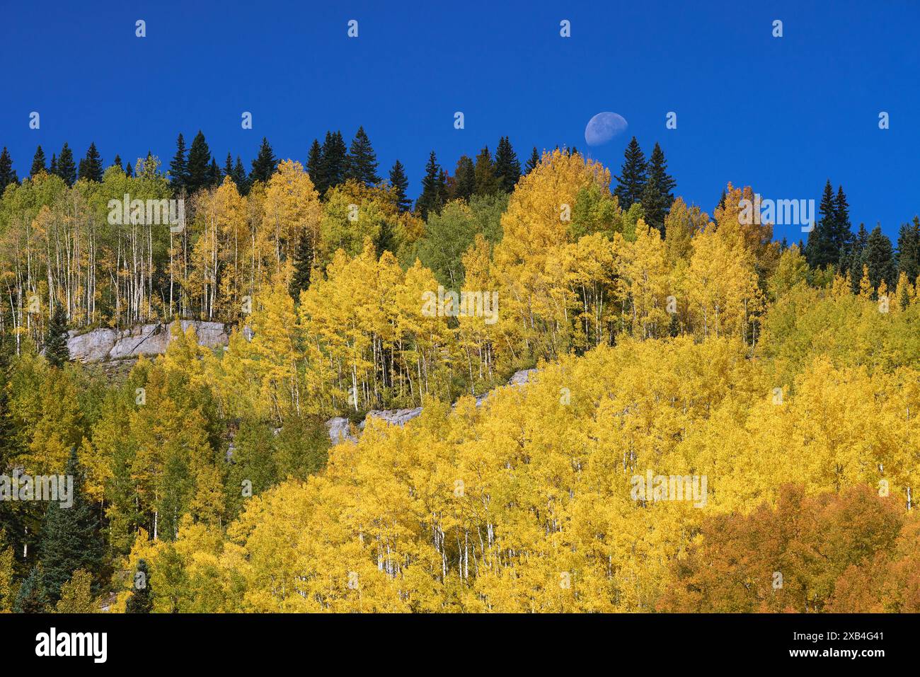Moon sets over a colorful ridge line along the Million Dollar Highway ...